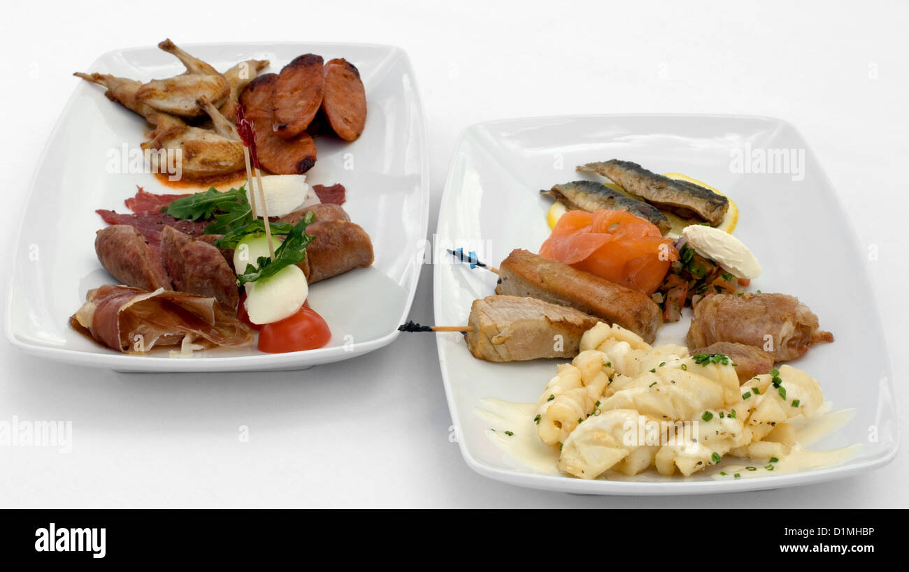 Entree tasting plates containing an assortment of seafood and meats ...