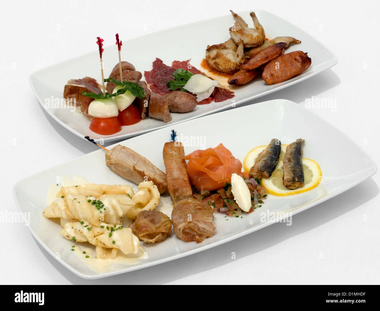 Entree tasting plates containing an assortment of seafood and meats ...