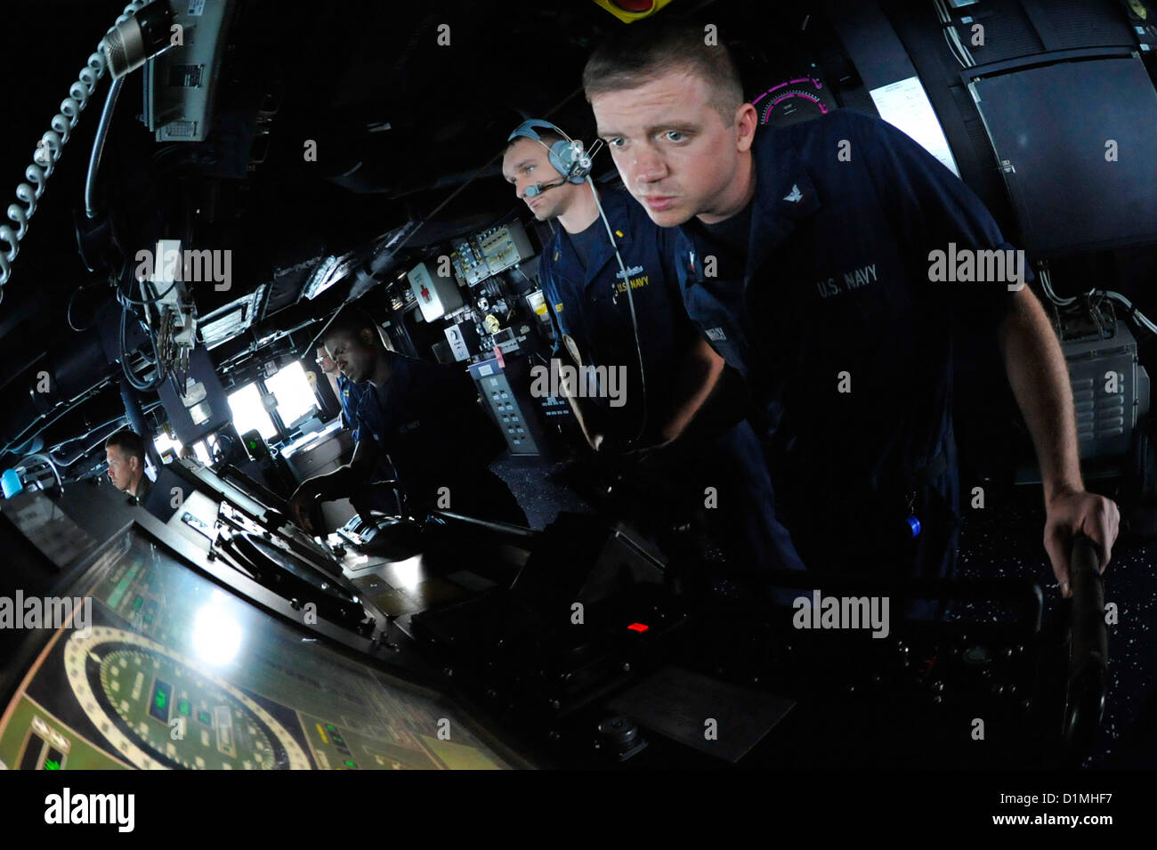 Sailors stand watch in the pilot house of the guided-missile destroyer ...