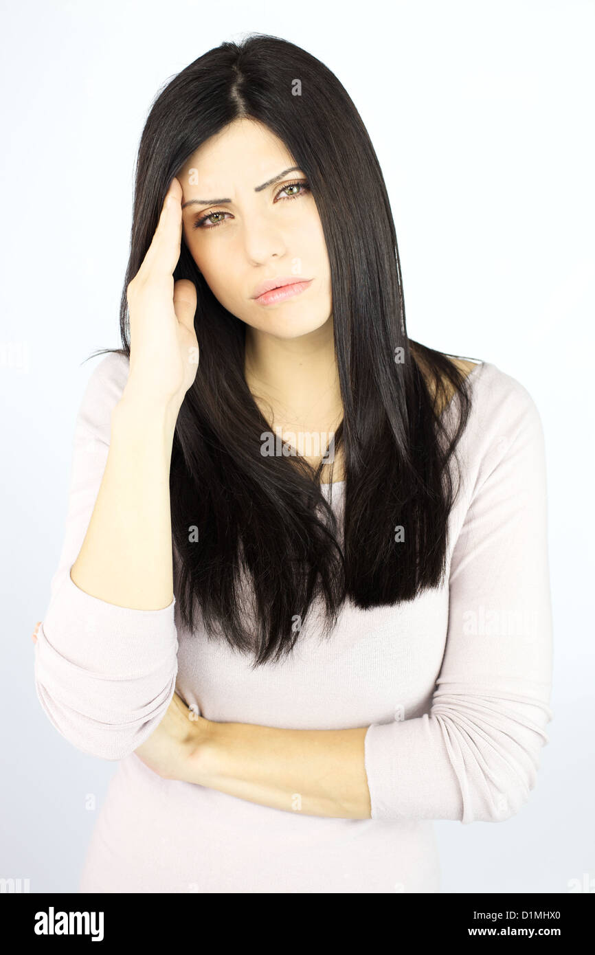 Beautiful woman sad about strong head ache suffering Stock Photo - Alamy