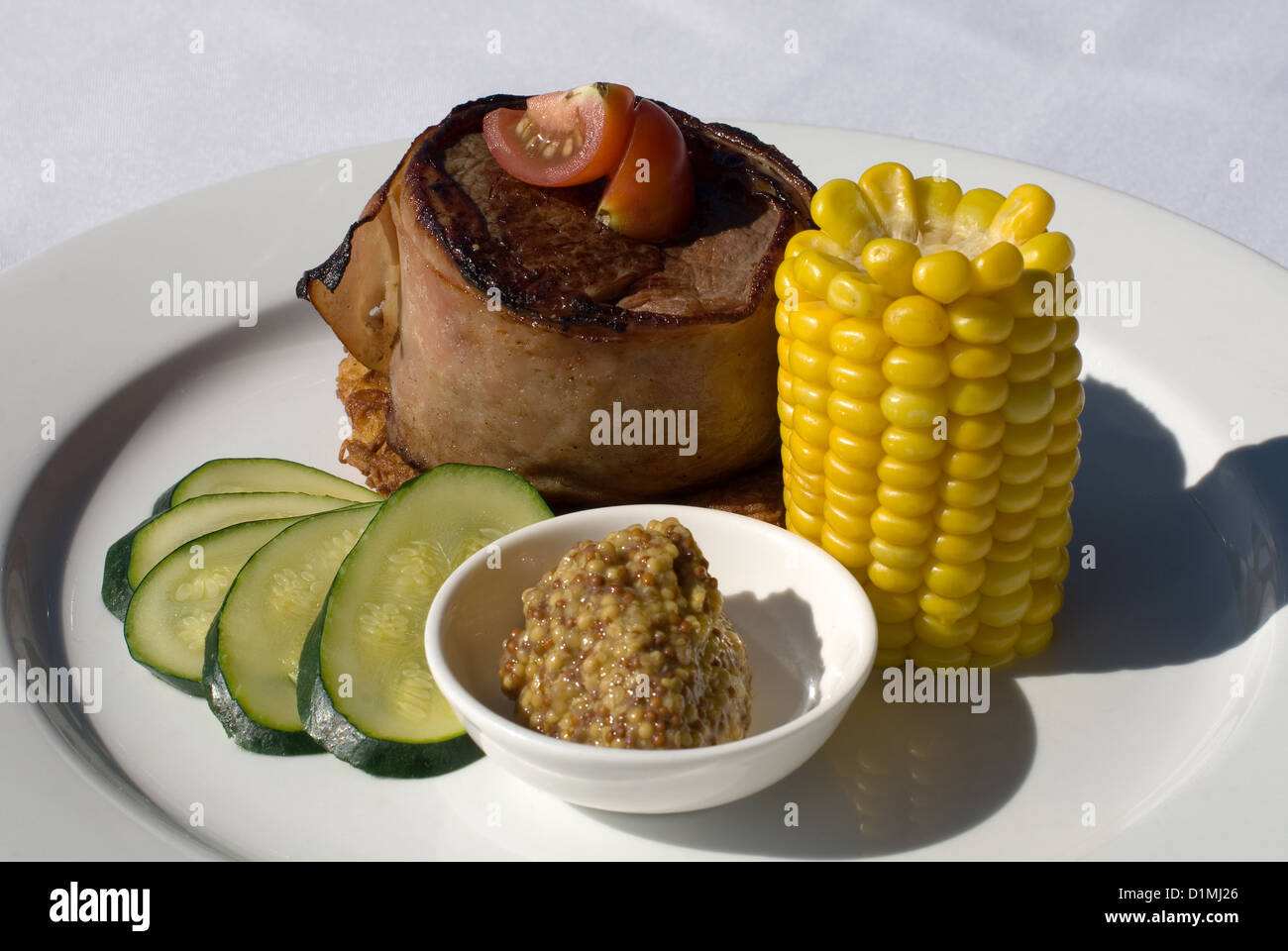 Filet Mignon, served on Potato Rosti, and accompanied by a Steamed Corn ...