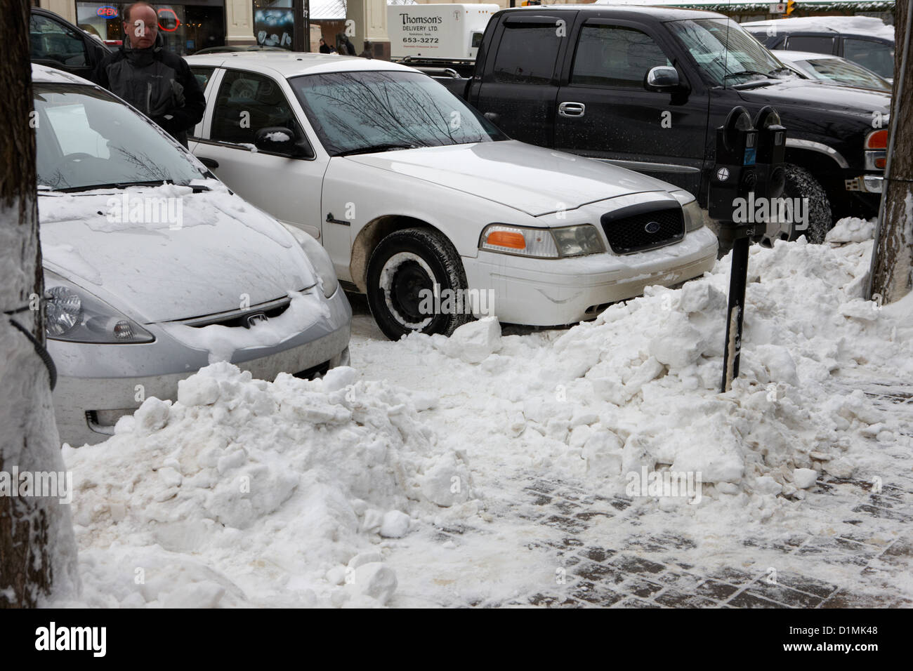 piles of snow cleared from sidewalk piled up at edge of sidewalk in ...