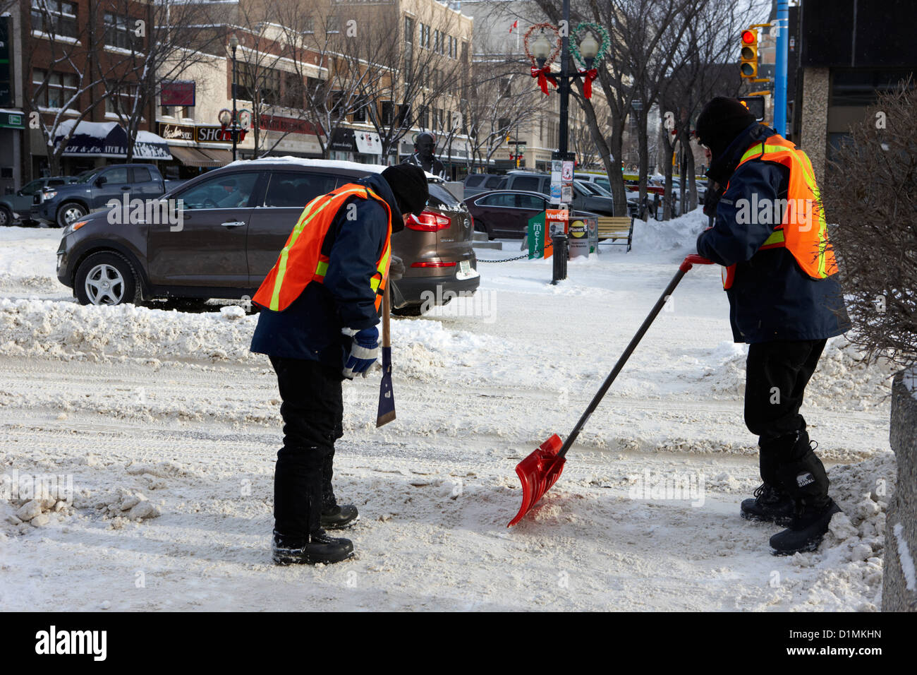 public workers clearing snow and ice off the sidewalks in downtown ...