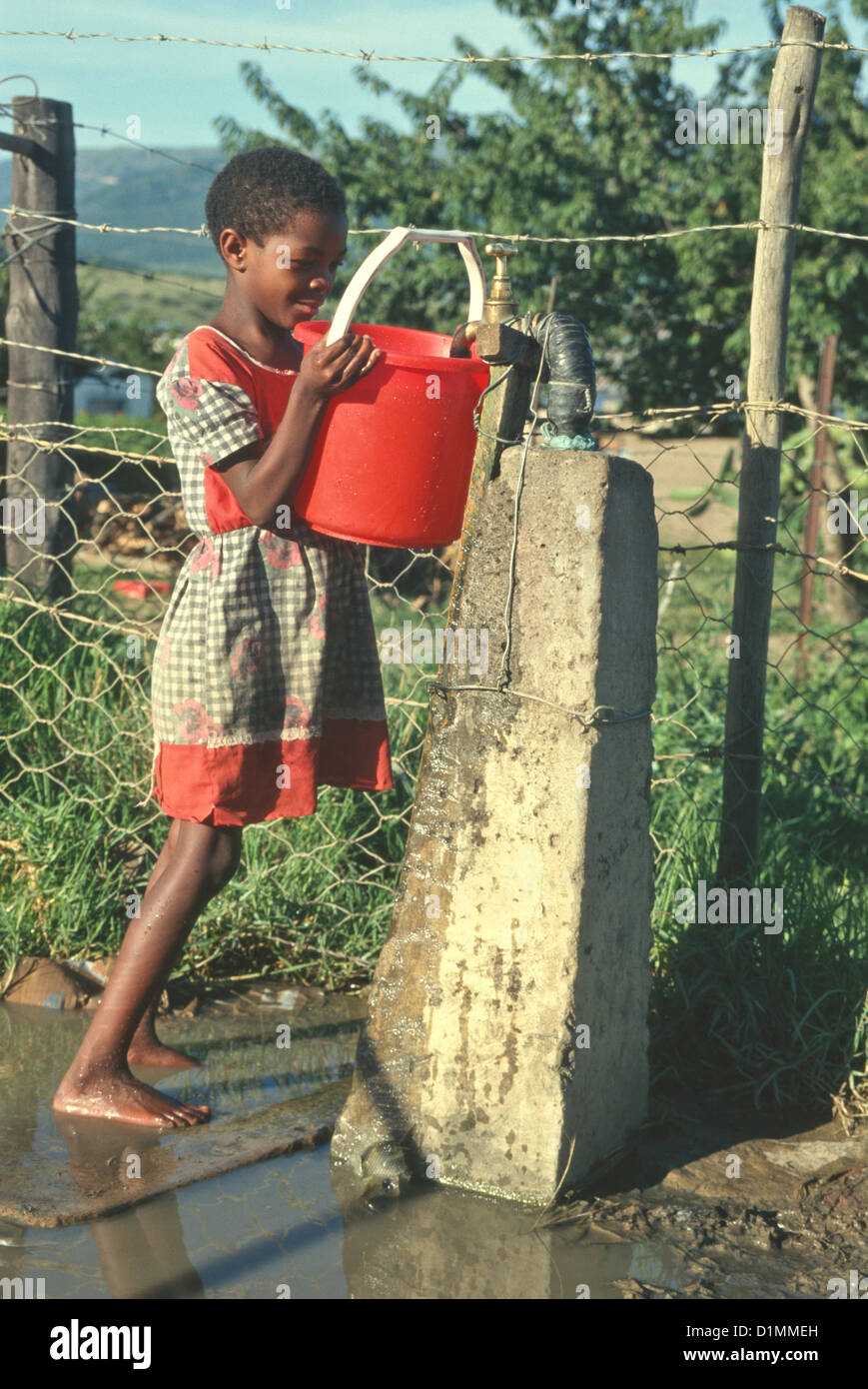 Girl fetching water from communal tap in a village in the eastern Cape ...