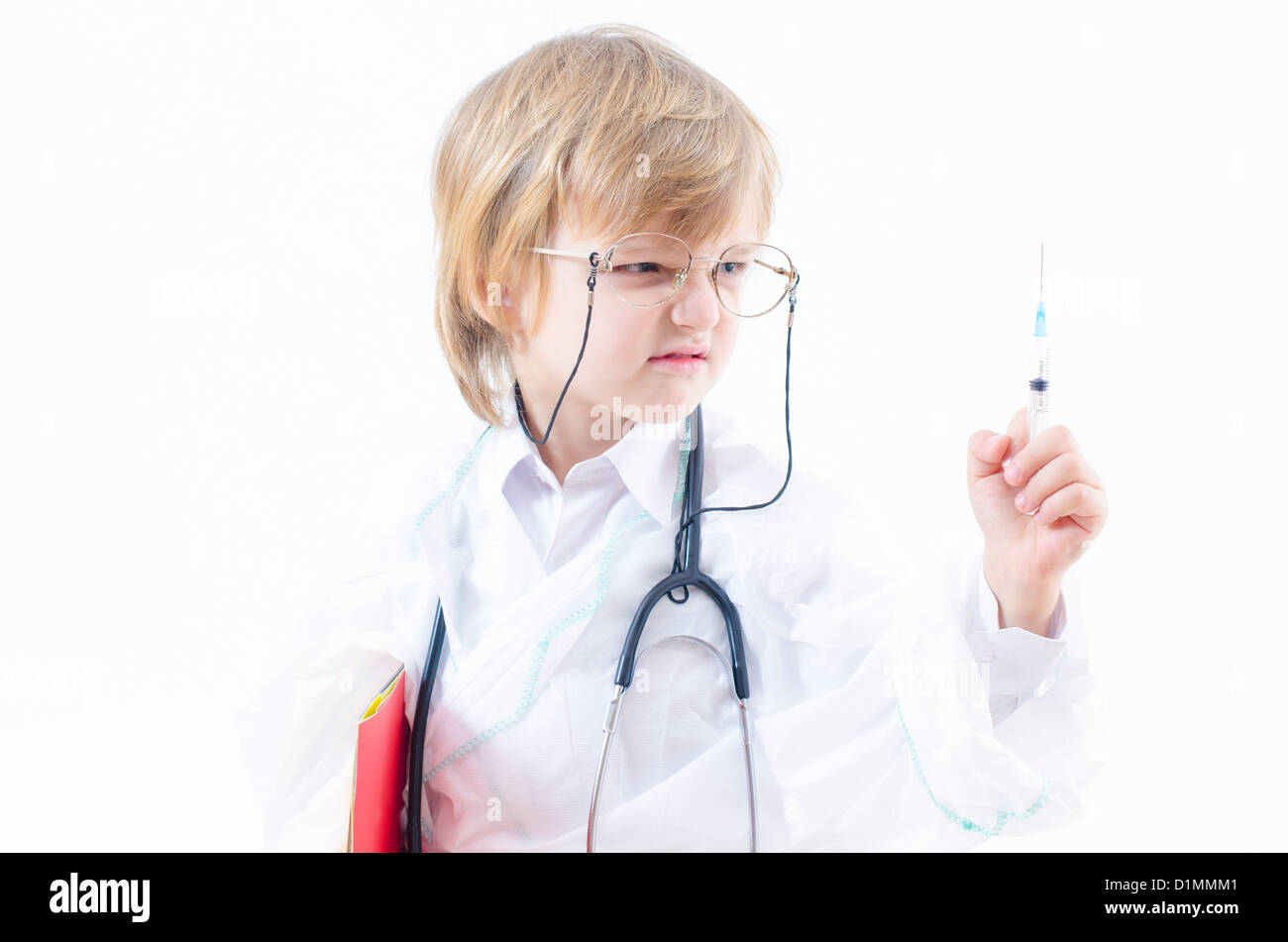 A cute boy equipped as a doctor holding a syringe Stock Photo - Alamy
