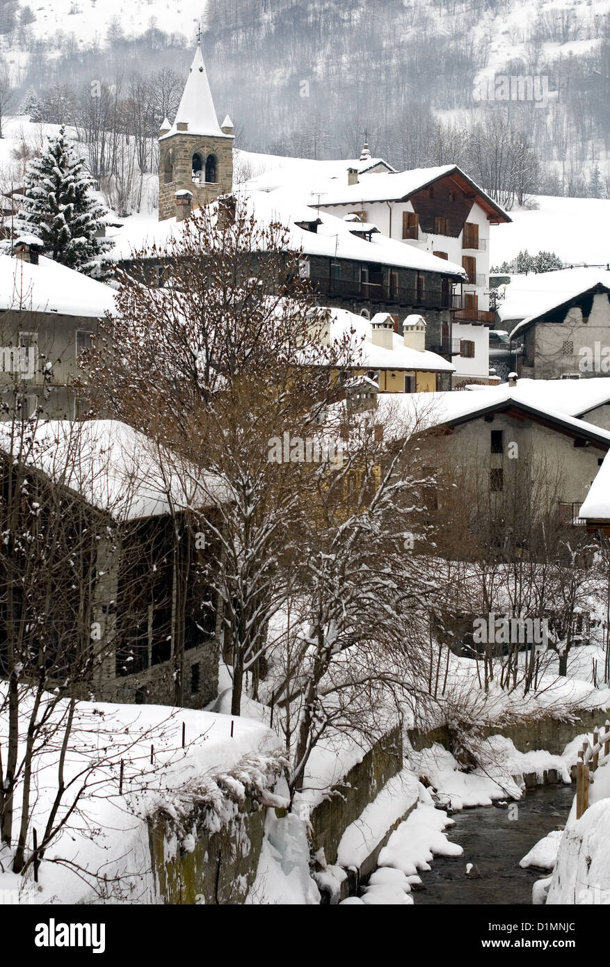 A narrow street in an alpine village, after a heavy snowstorm, Italy ...