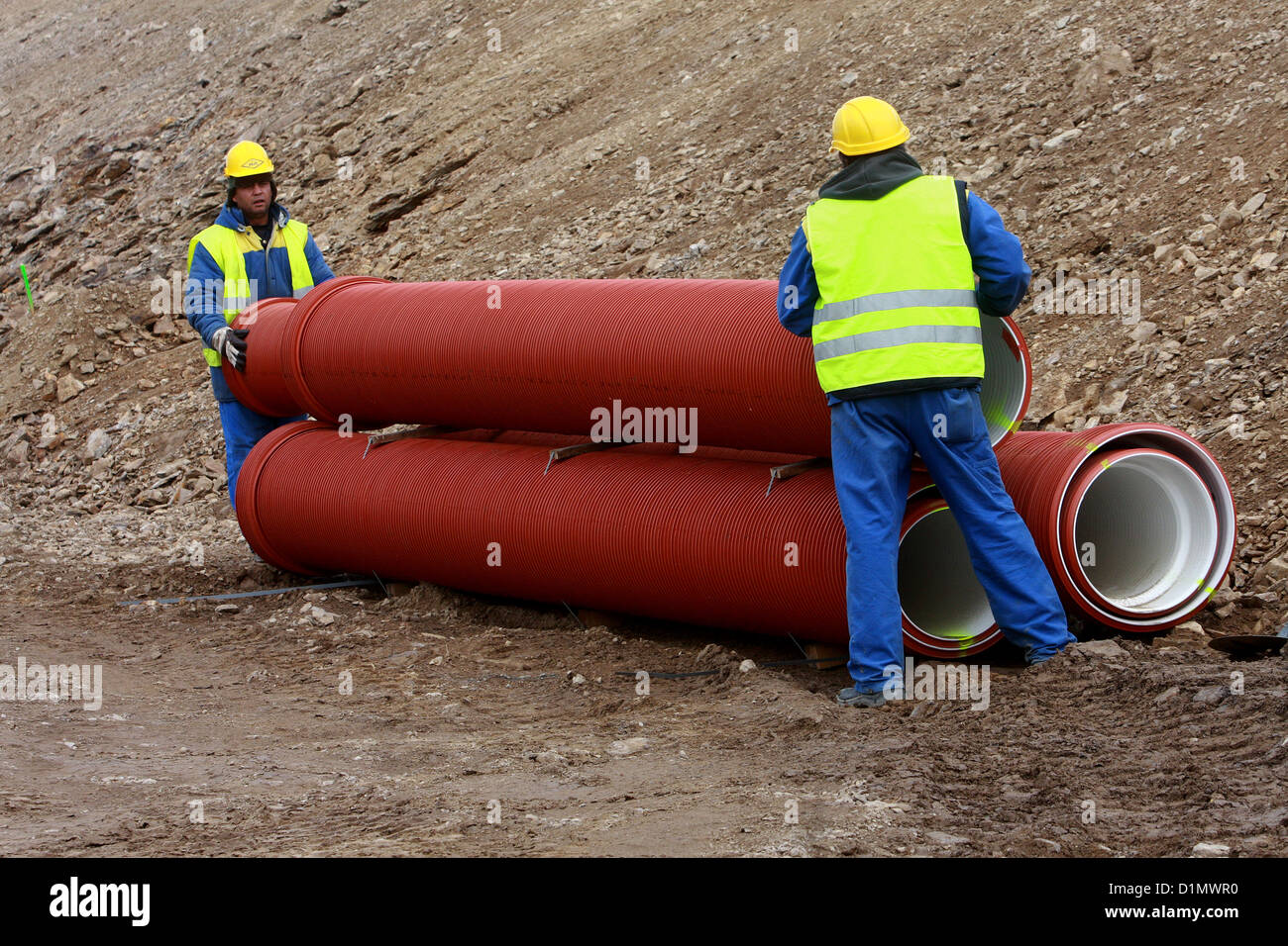 Construction site pipe workers Stock Photo - Alamy