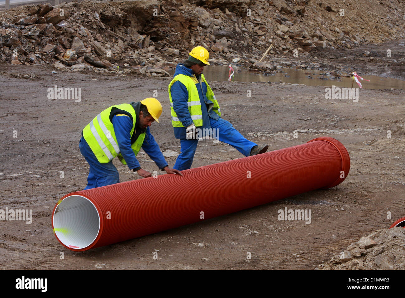 Construction site pipe workers Stock Photo - Alamy