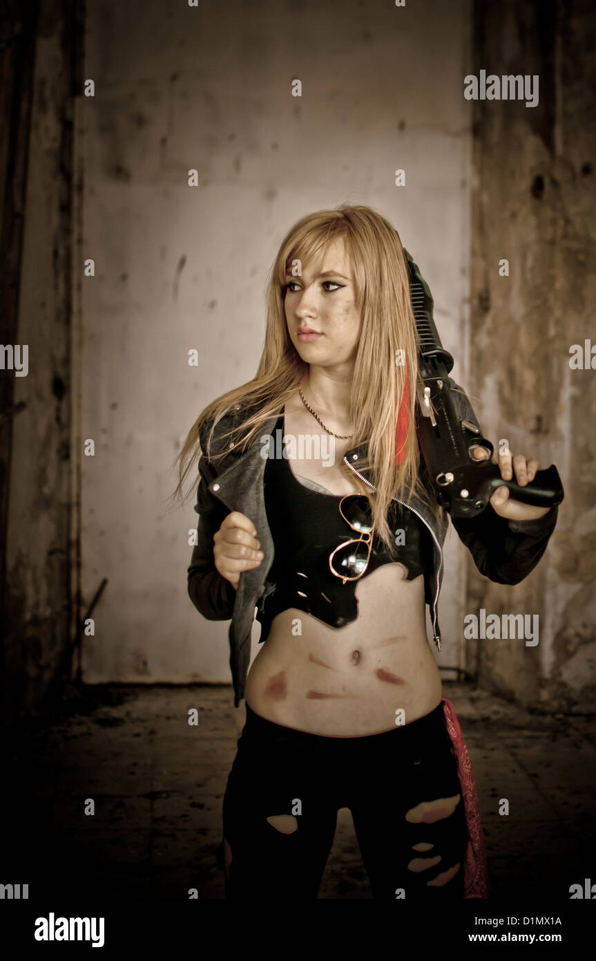 Aggressive Young woman in her 20s with automatic rifle Stock Photo - Alamy