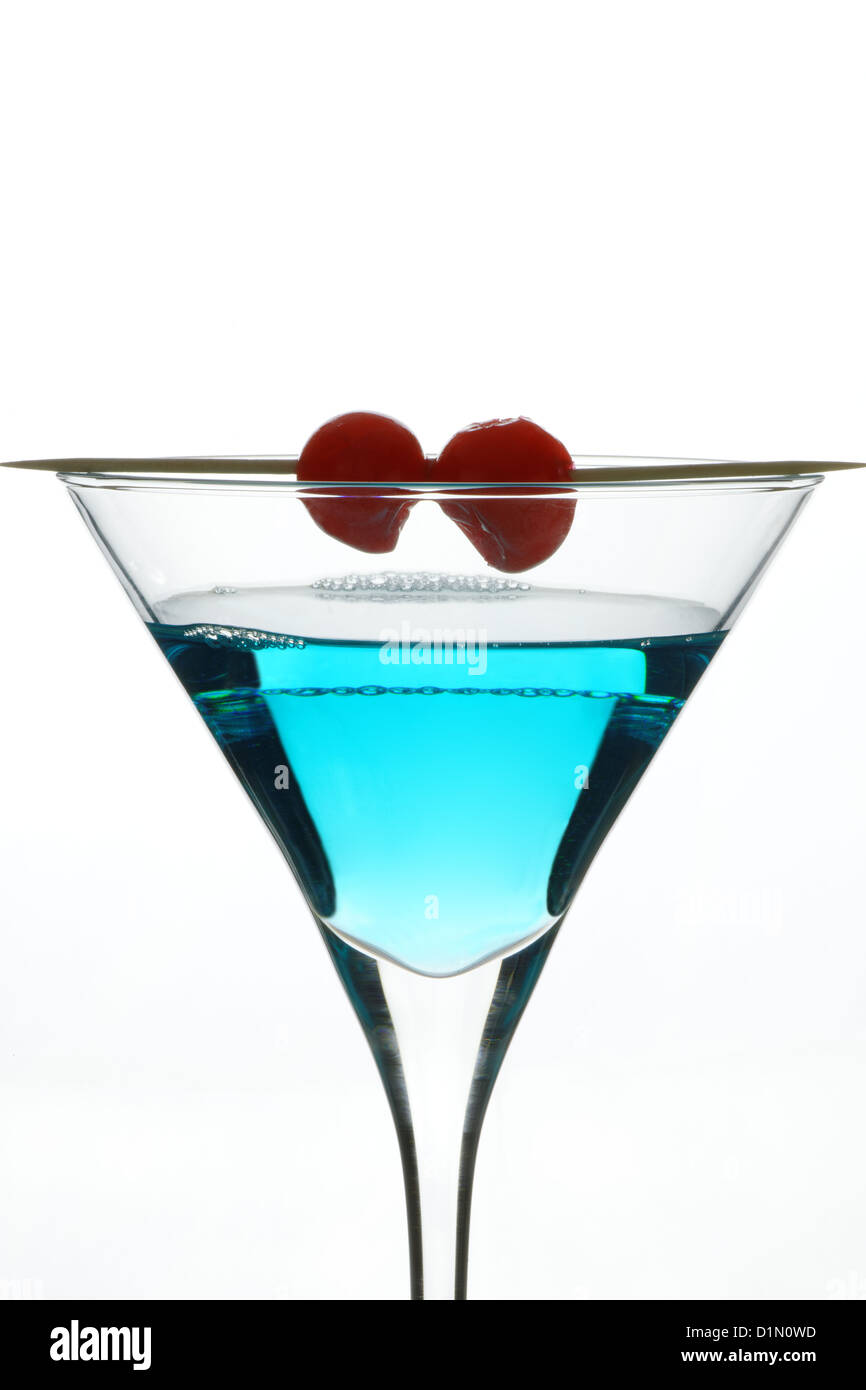 Blue cocktail with cherries on a stick against white Stock Photo - Alamy