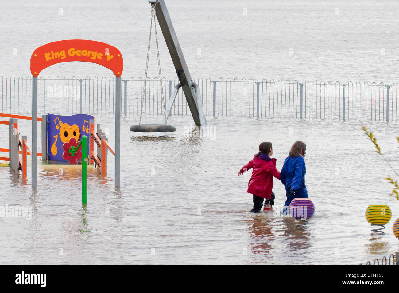 Hereford, UK. 30th December 2012. Two young girls walk in the flooded ...