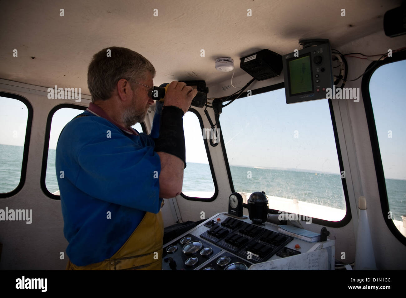 Richard, owner and captain of his small fishing boat is heading out to ...