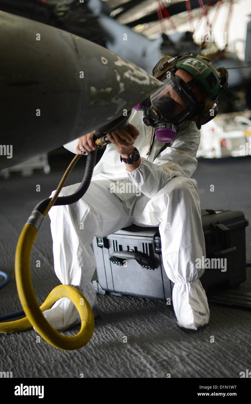 Aviation Structural Mechanic 1st Class Gregory Priebe prepares an F/A ...