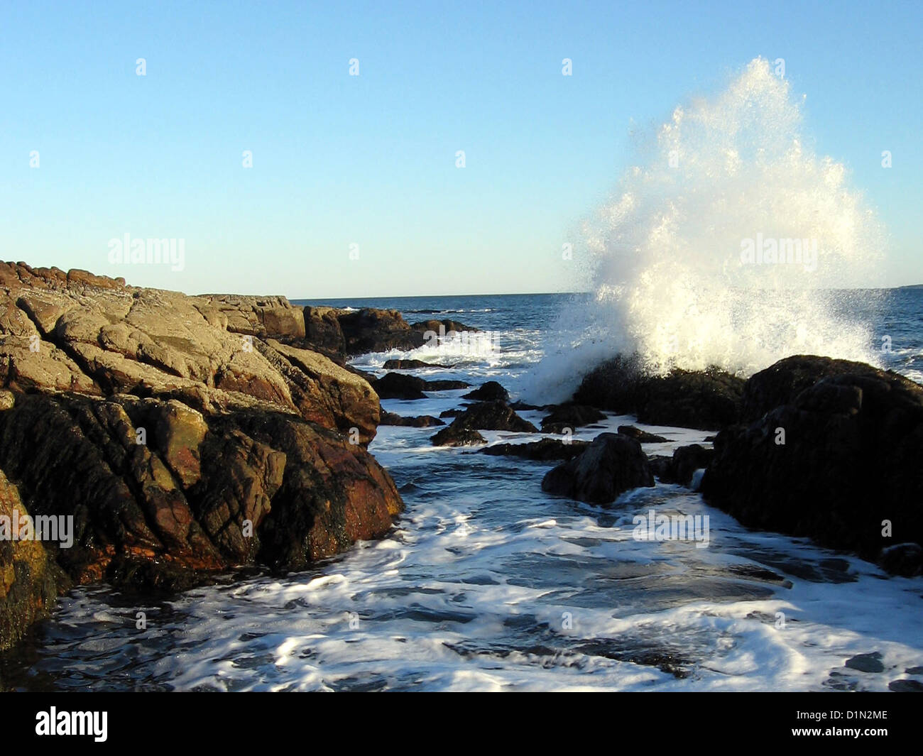 A wave crashes on the rocky coastline of Ship Harbor at Acadia National ...
