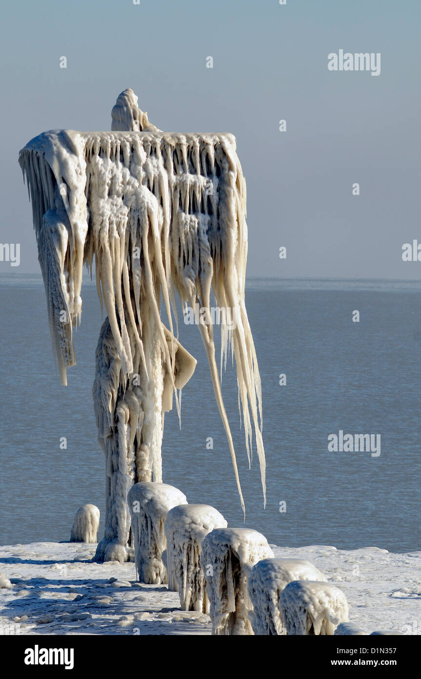 A light standard covered with ice on the shore of Lake Michigan in ...