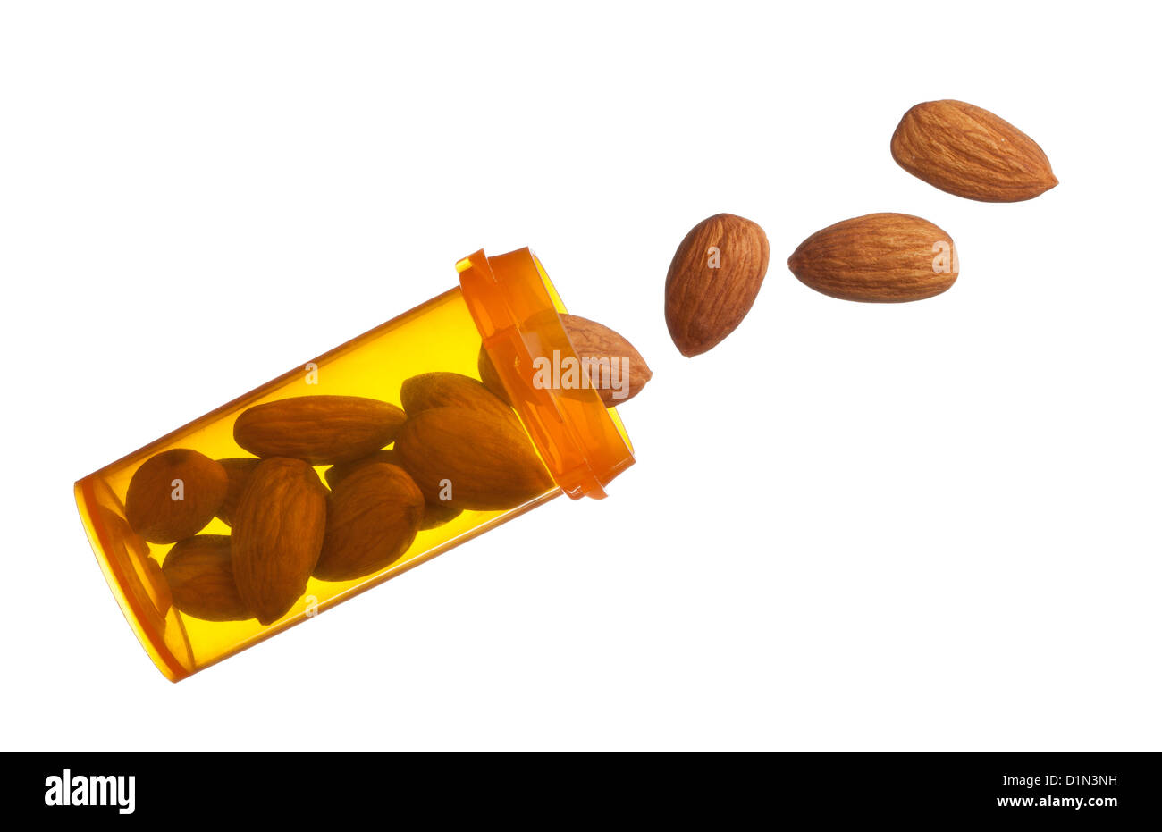 Almonds in a pill bottle isolated on white background Stock Photo - Alamy