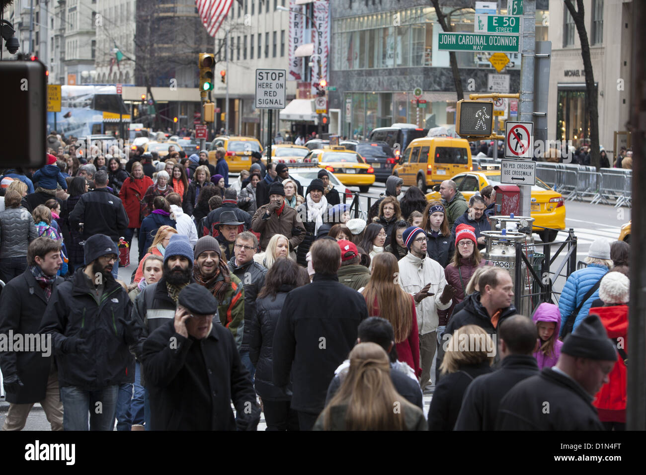 Crowds of shoppers, tourists and New Yorkers walk on 5th Ave at ...