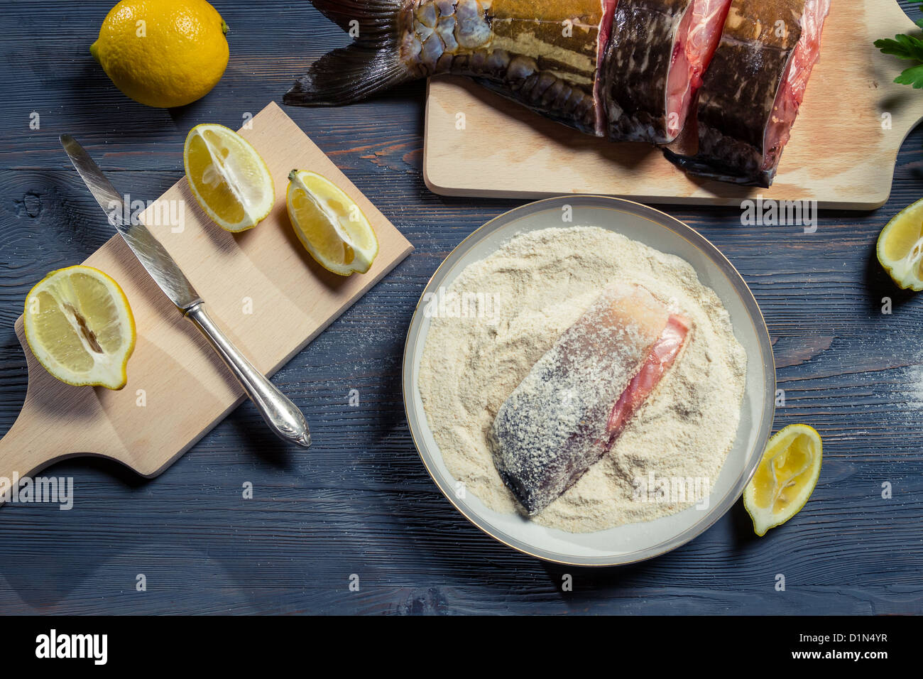 Fresh fish, flour and lemon as ingredients in a dish Stock Photo - Alamy