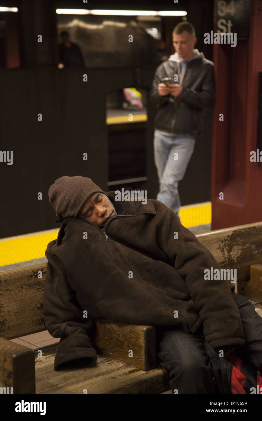 Homeless man sleeping on bench hi-res stock photography and images - Alamy