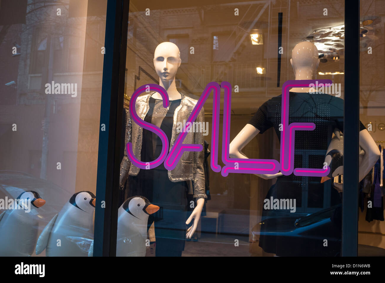 Sale sign in the window of a women's clothing store in New York City ...