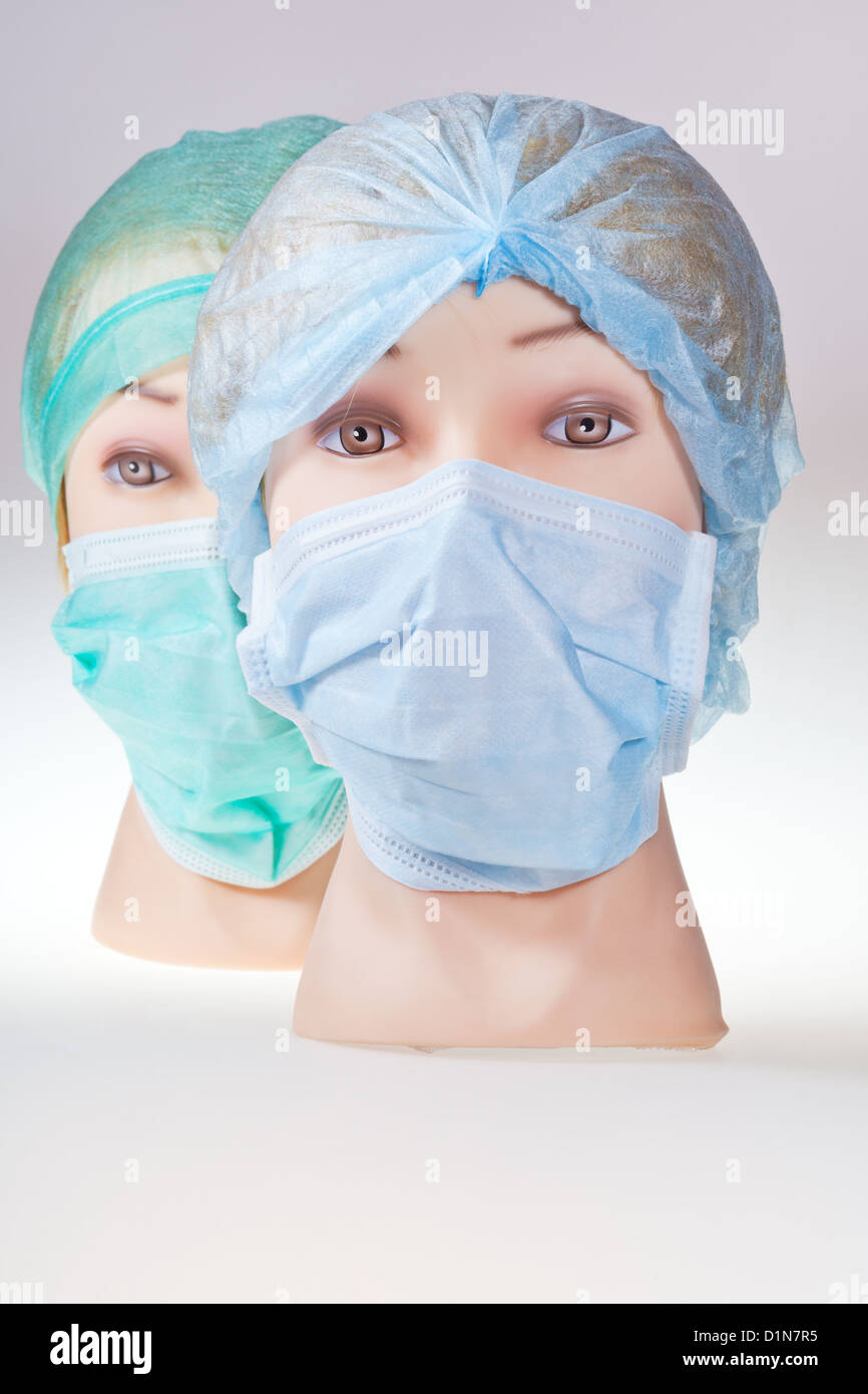two women's dummy doctor heads wearing textile surgical cap and medical ...