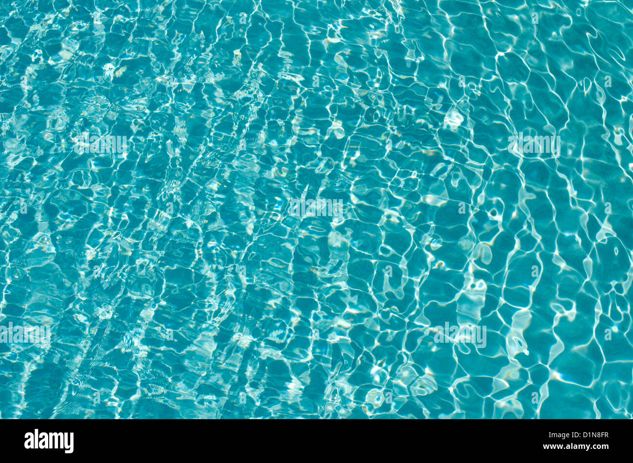 Blue pool water with sun reflections Stock Photo - Alamy