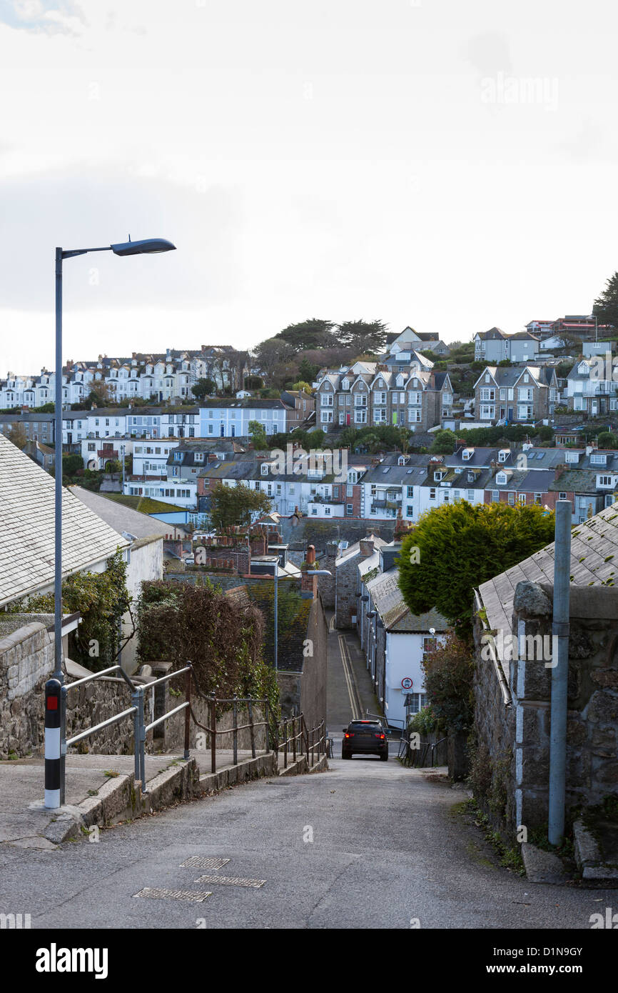 A car slowly descends one of the many steep and narrow lanes in St Ives ...
