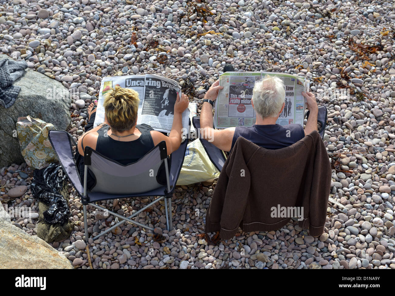 Beach reading newspaper newspapers hi-res stock photography and images ...