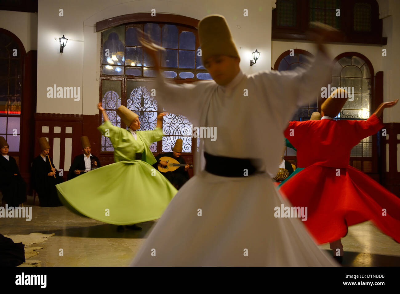 Spinning male and female Whirling Dervishes in a Sema Ceremony with ...