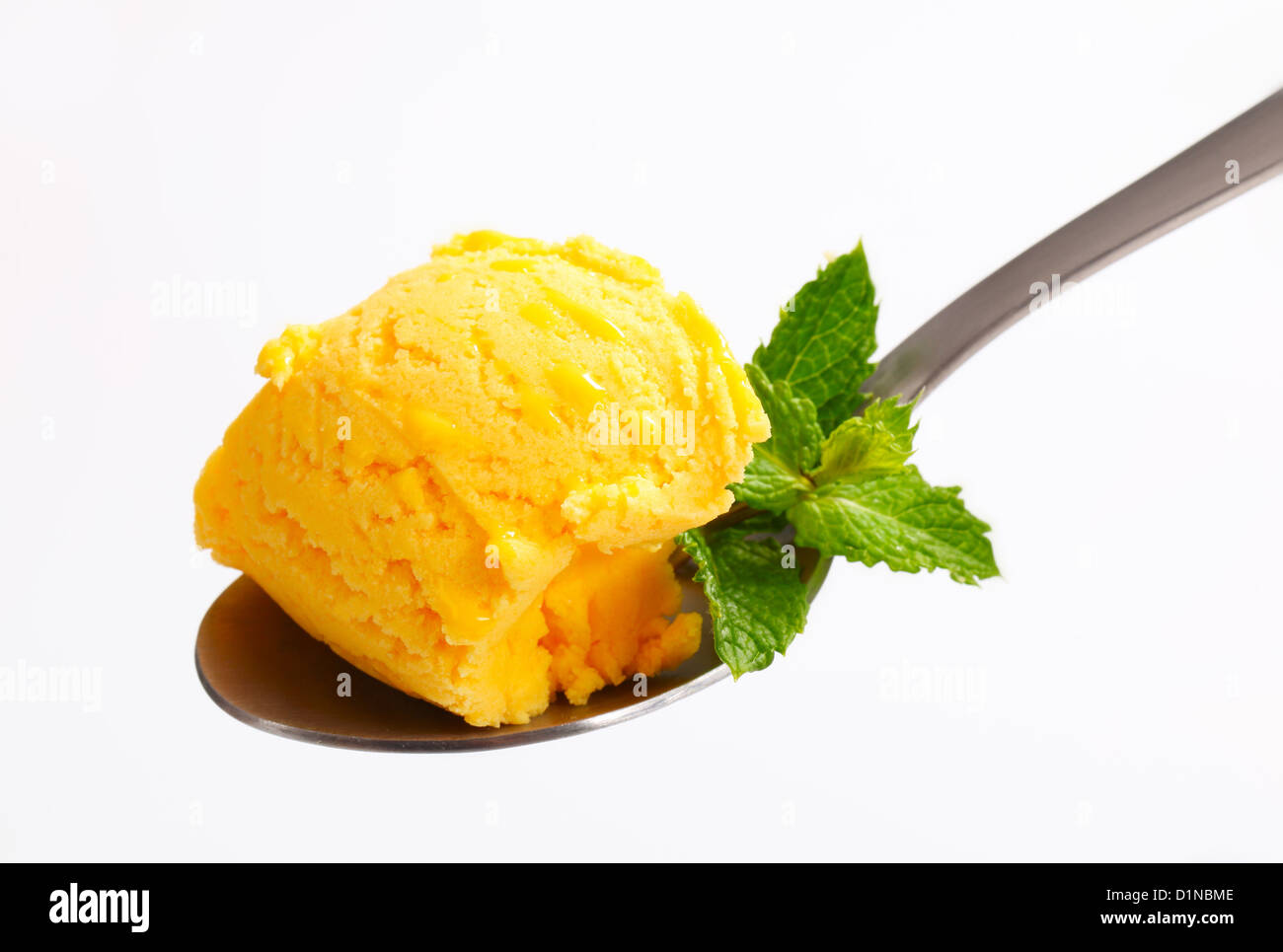 Yellow ice cream on a spoon Stock Photo - Alamy