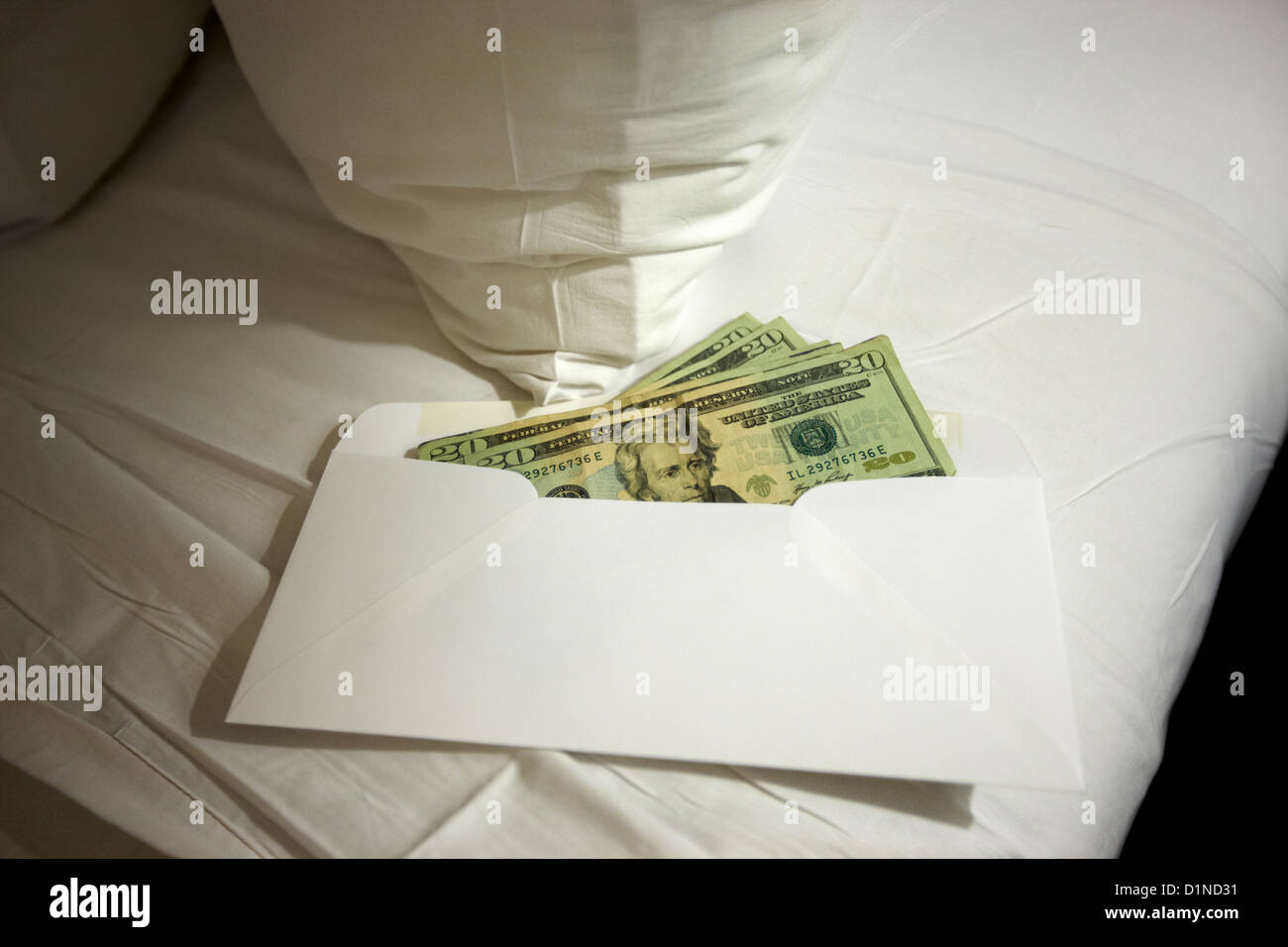 us dollars cash left in an envelope by the side of the bed in a hotel ...