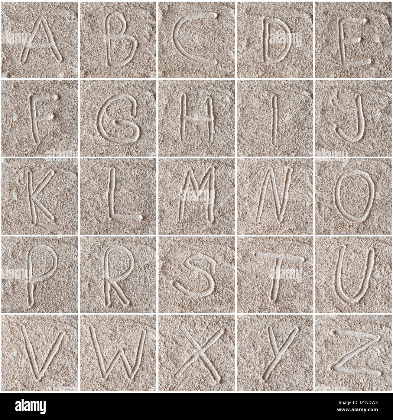 handwritten alphabet letters on flour, grain, dust mixture, on the ...