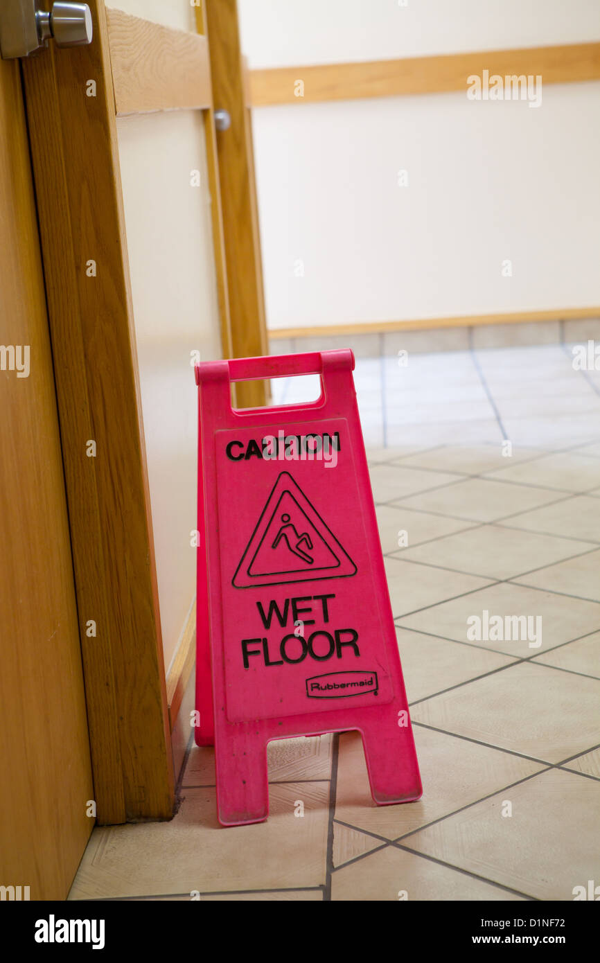 Wet floor sign on empty clean hallway Stock Photo - Alamy