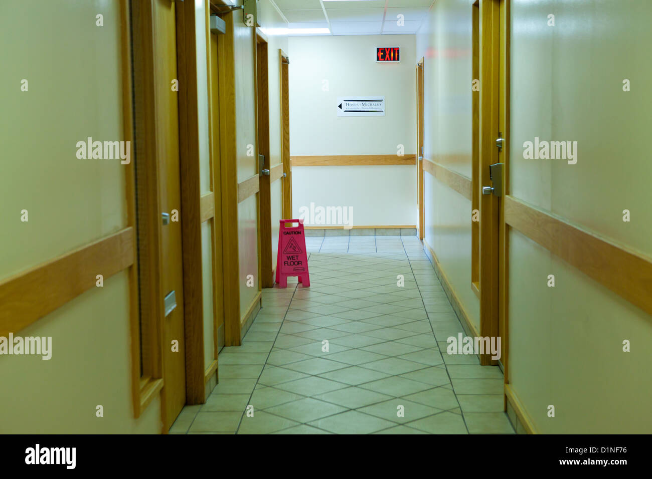 Wet floor sign on empty clean hallway Stock Photo - Alamy
