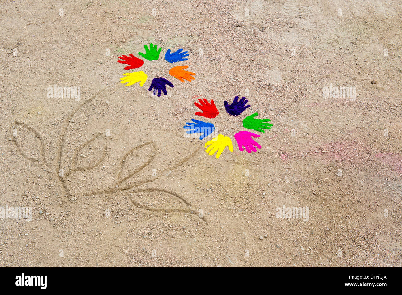 Coloured powder hand prints in a circular pattern made into a flower on ...