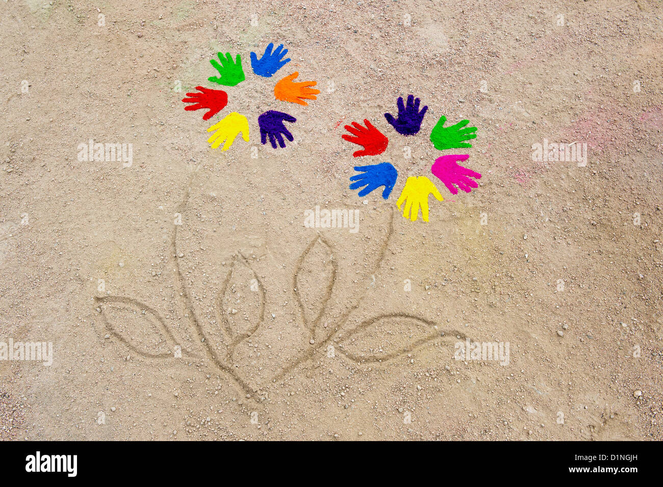 Coloured powder hand prints in a circular pattern made into a flower on ...