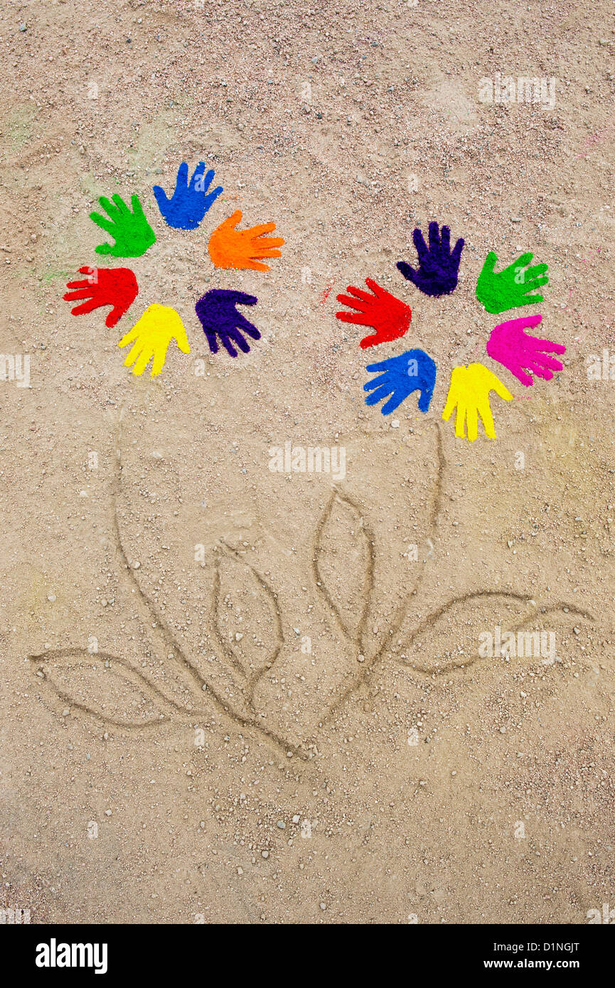 Coloured powder hand prints in a circular pattern made into a flower on ...