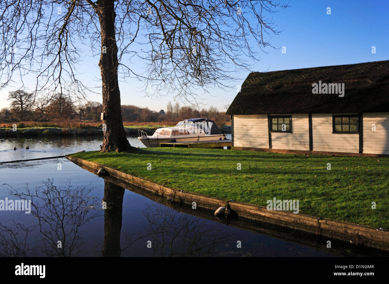 A view of a boathouse and launch moored by the River Bure at Coltishall ...