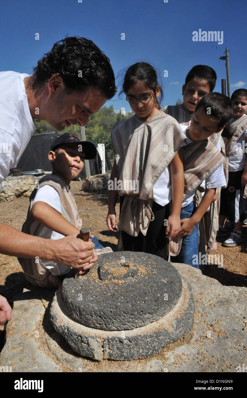 Children experience hand operated millstone hi-res stock photography ...