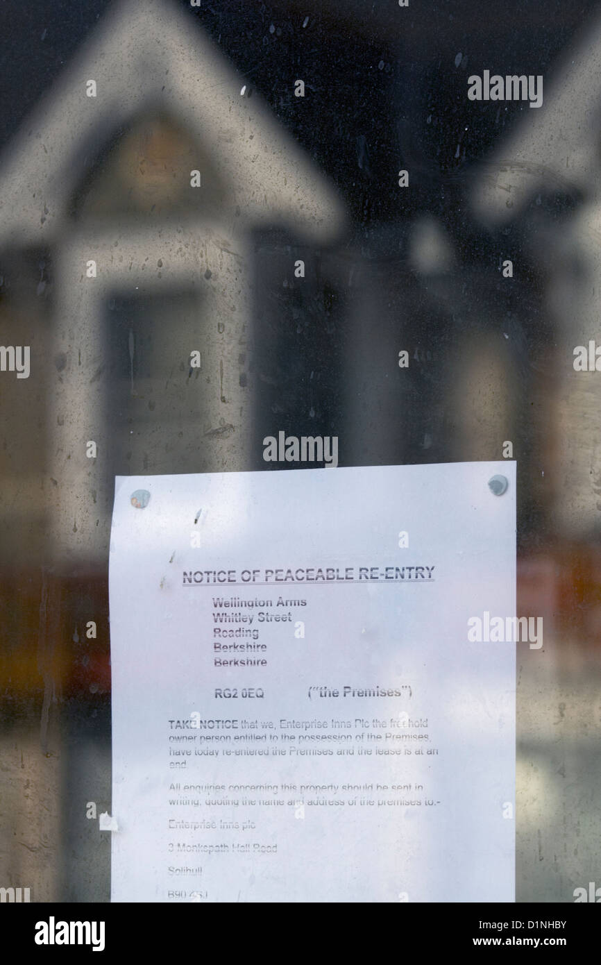 A repossession notice on a public house (pub), reflecting houses in the ...