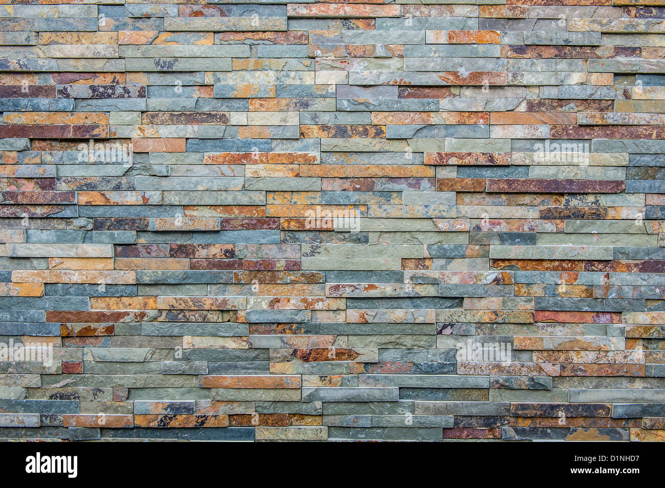 Multi Coloured and Textured Stone Wall Stock Photo - Alamy