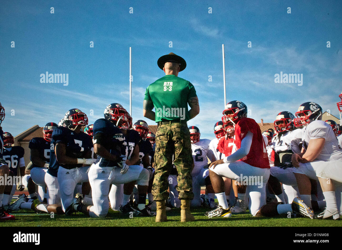 Corey Cooper, wide receiver for the East Coast Team, stiff arms a ...