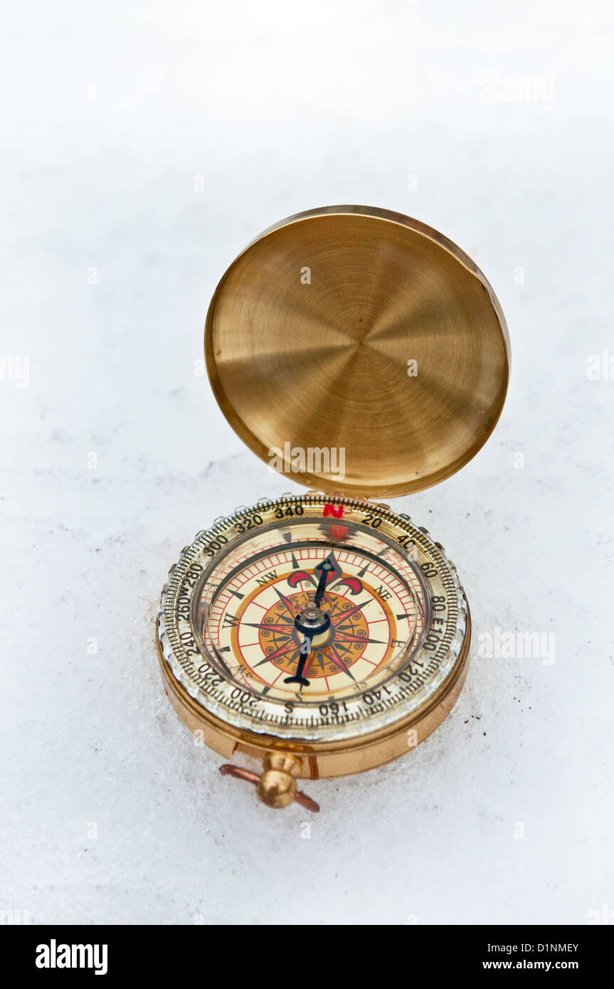 Compass instrument in the snow, navigation concept Stock Photo - Alamy