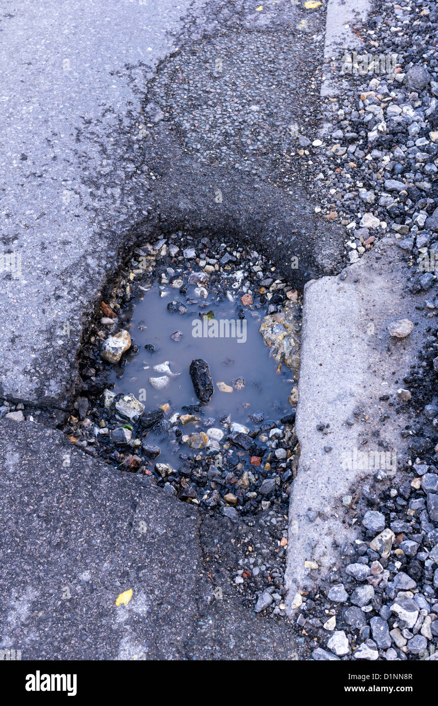 Pothole in the road Stock Photo - Alamy