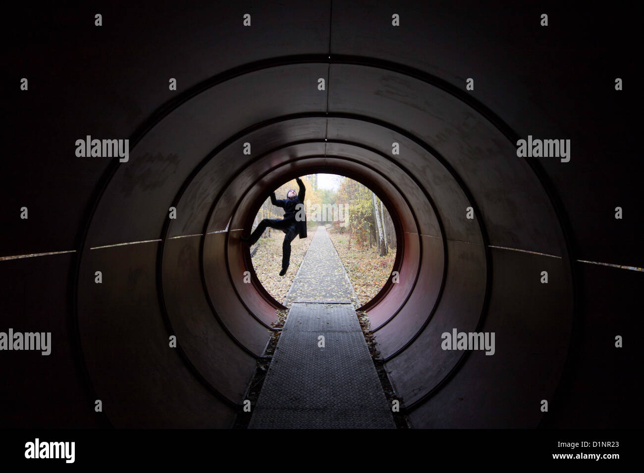 Man in a tunnel attempting to climb out, man escapes tunnel, light at ...