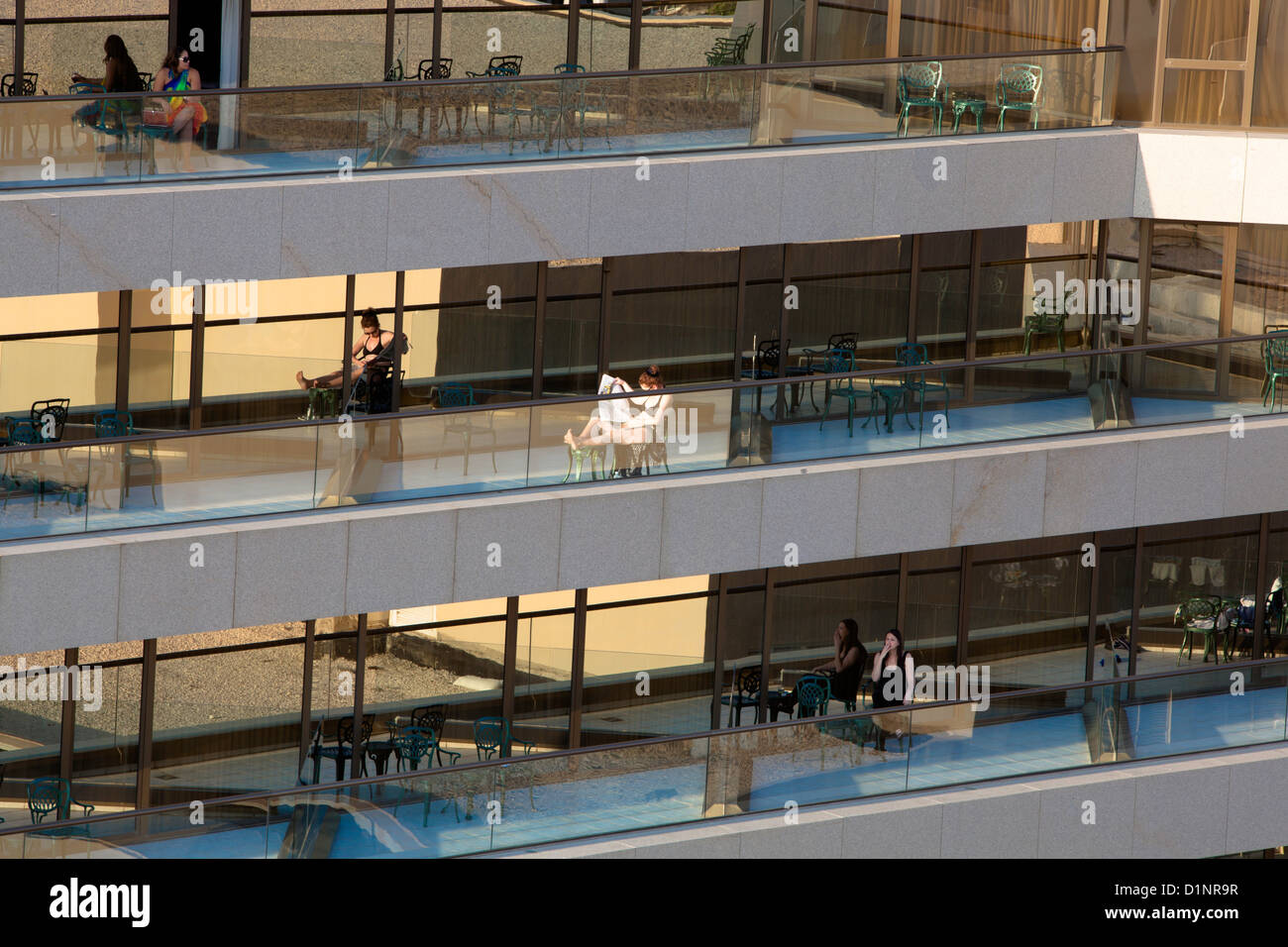 People relaxing on hotel balcony reflections Stock Photo - Alamy