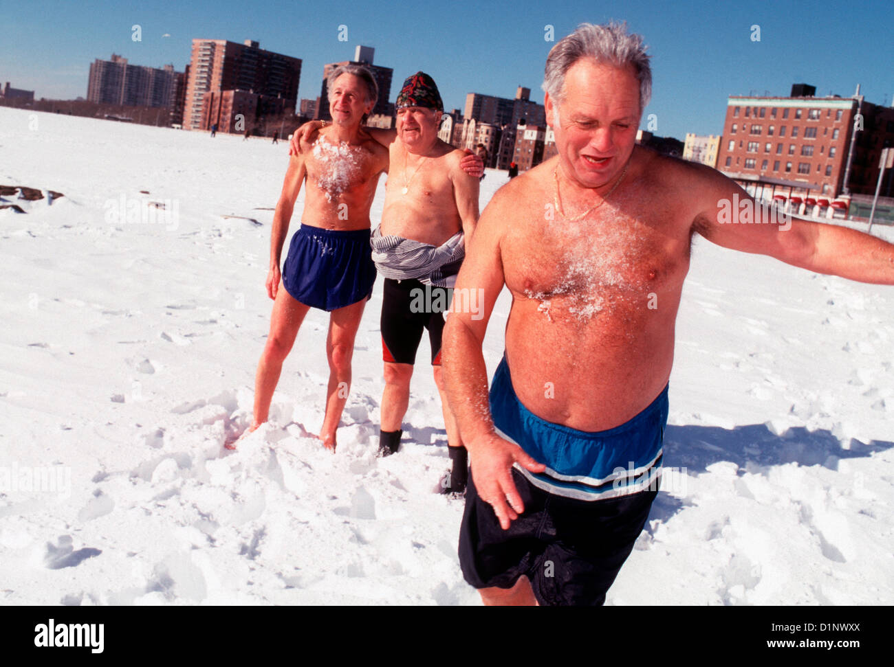 Members of the Coney Island Ice Breakers cavort in the snow and surf ...