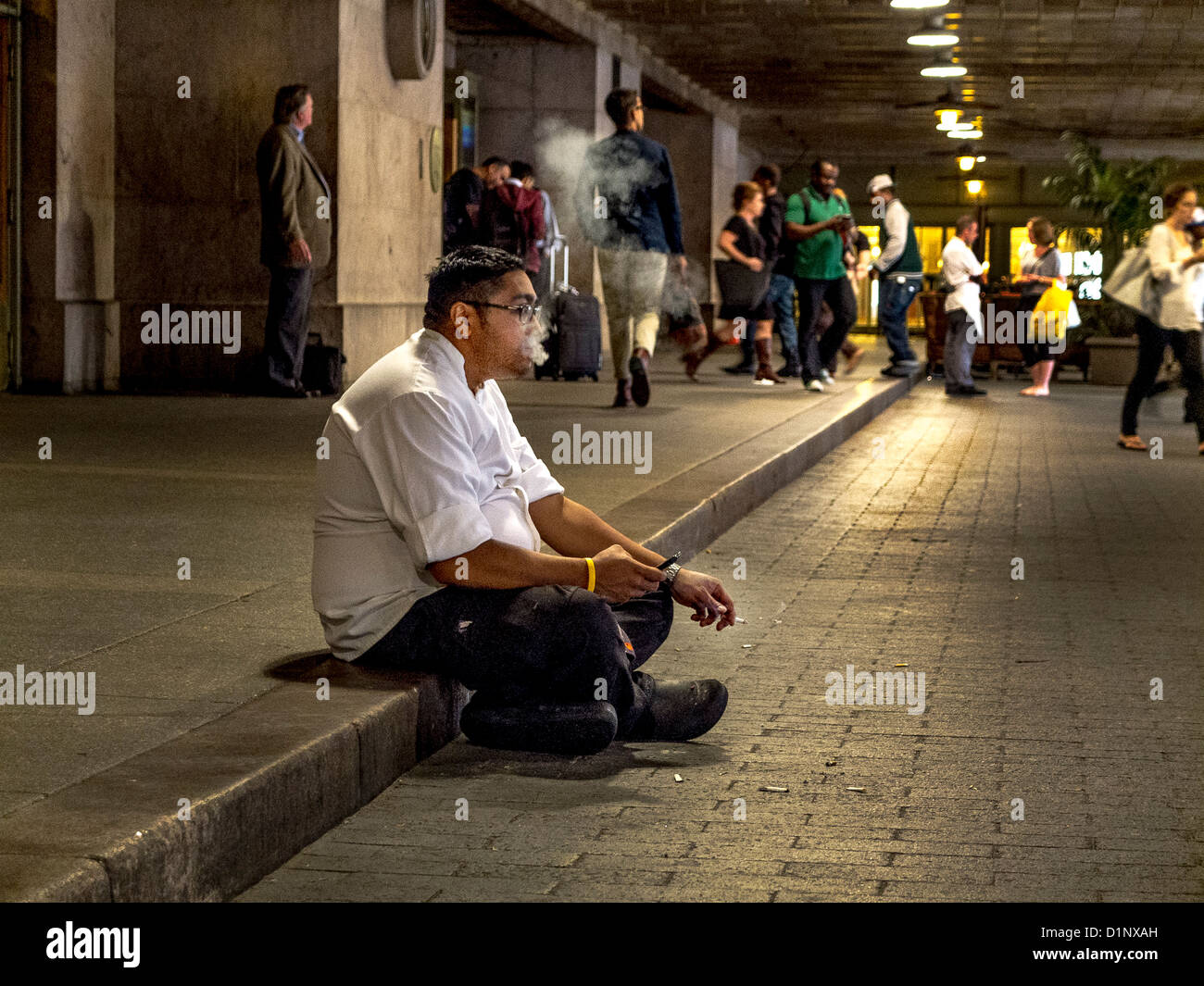 A white-coated restaurant employee smokes on the sidewalk outside New ...