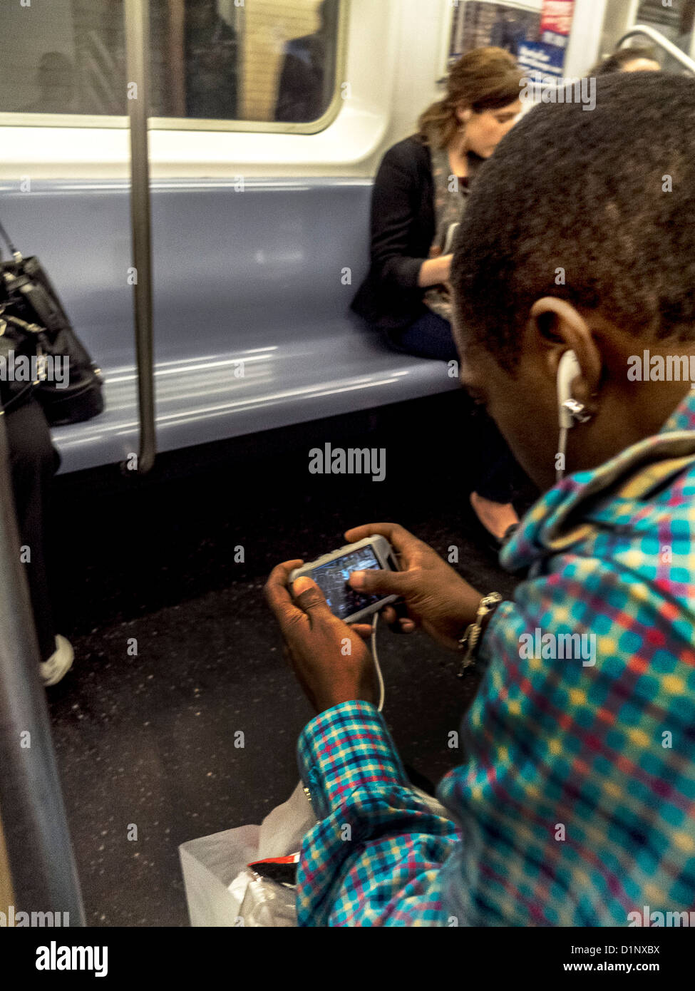 Video game on the subway hi-res stock photography and images - Alamy
