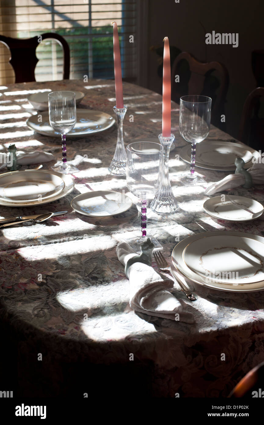 Formal table setting with strong light shinning through the window ...